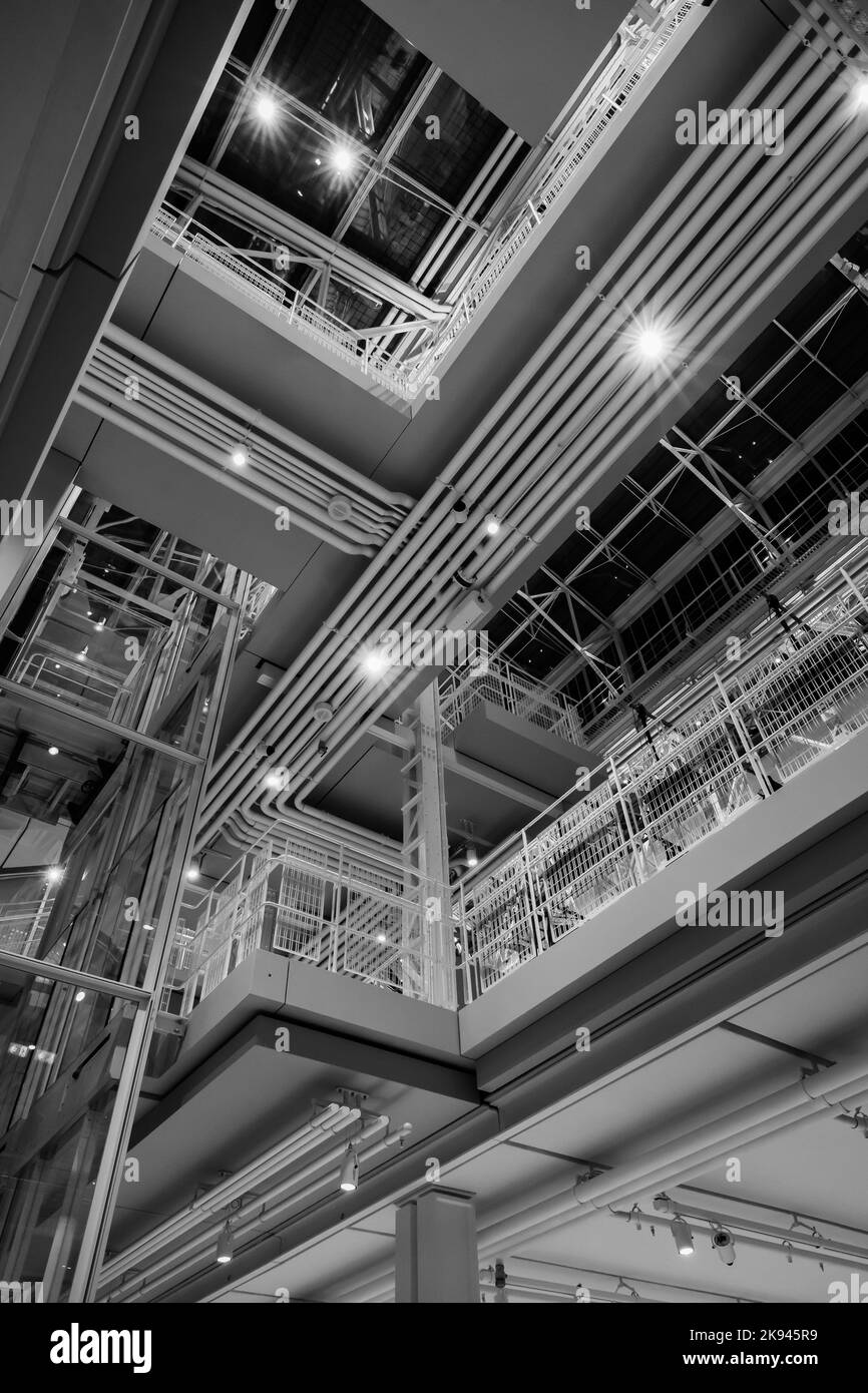 From below black and white shot of pipes and lamps attached to bridge ...