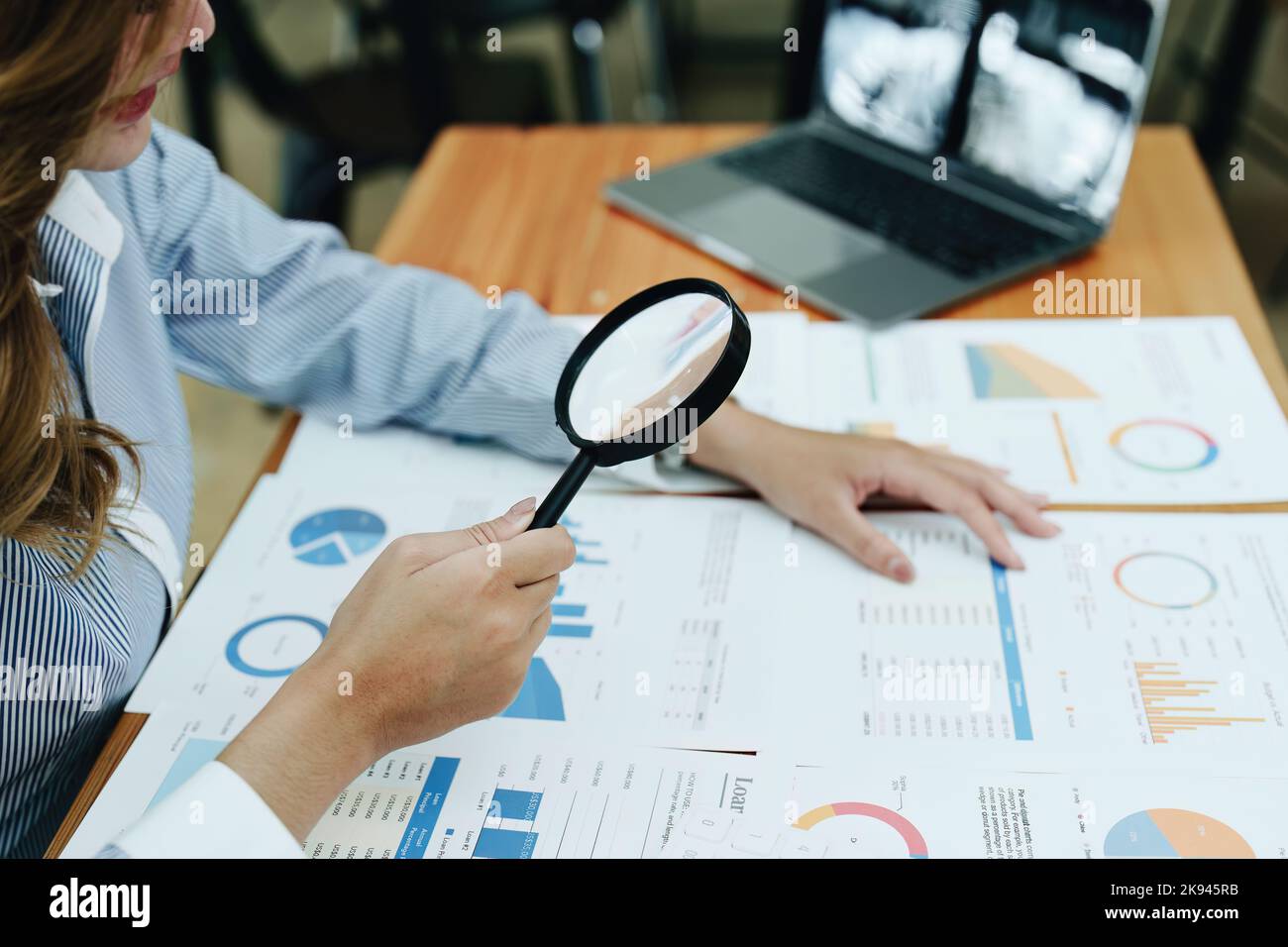 Financial analysts analyzing business financial reports are examining ...