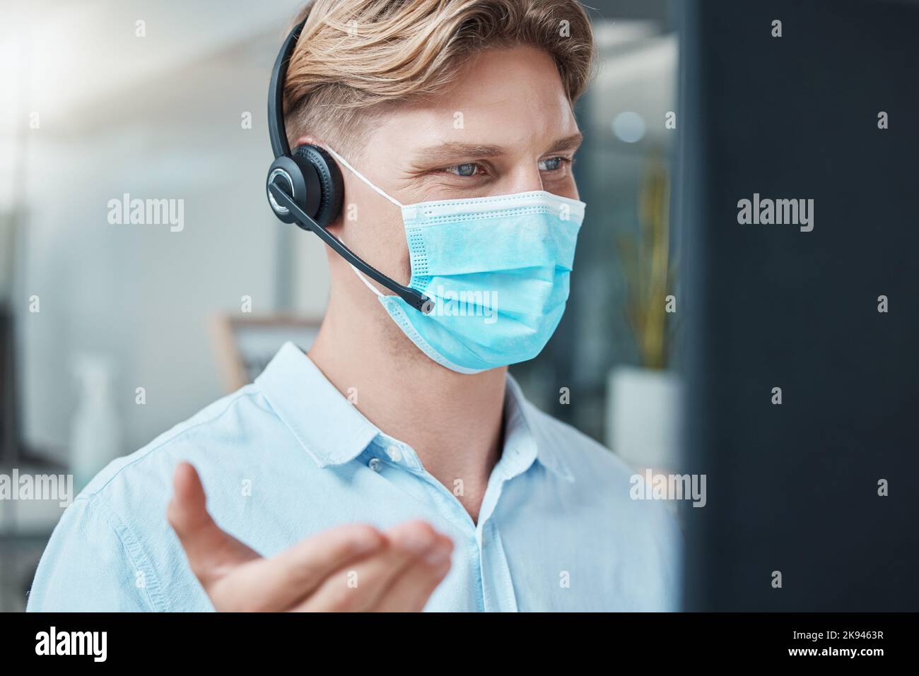 Call center, face mask and telemarketing agent talking on headset for ...