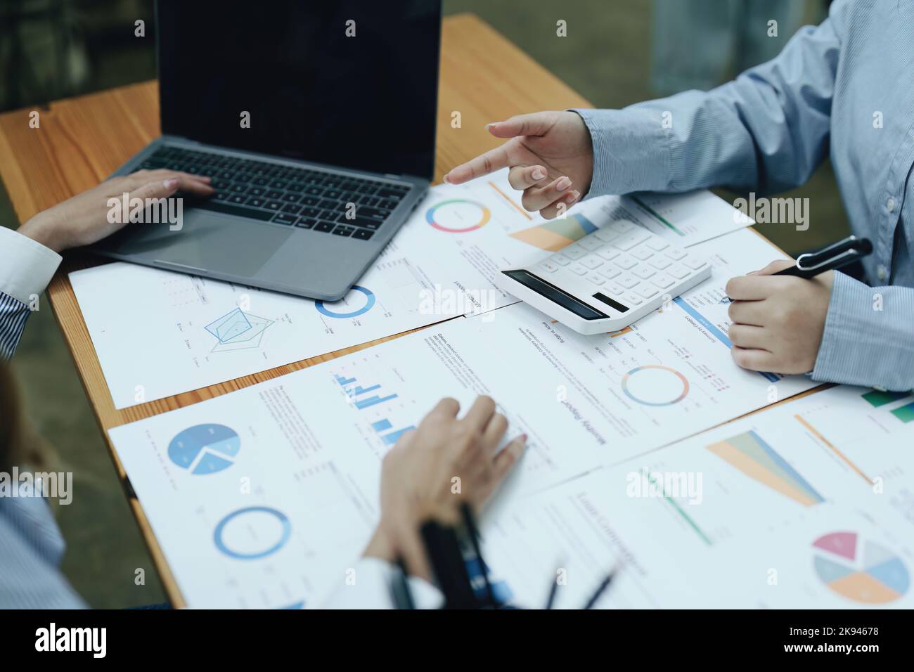 Financial analysts analyzing business reports on planned investment ...
