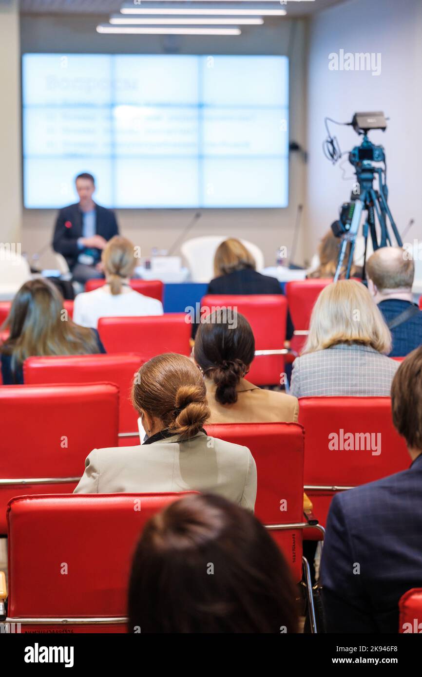 People listening to online speaker during business seminar in narrow ...