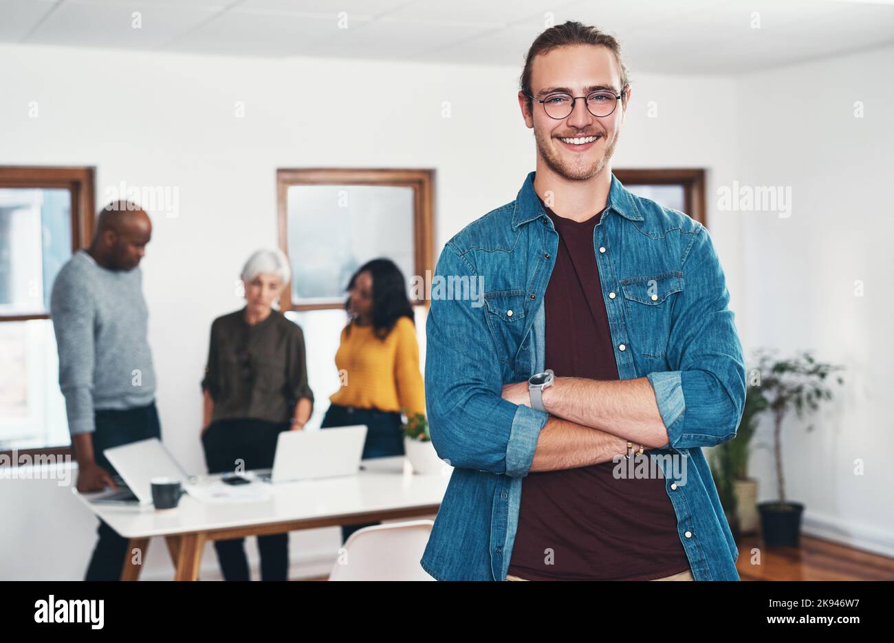I am glad that Ive decided to work here. Portrait of a cheerful young ...