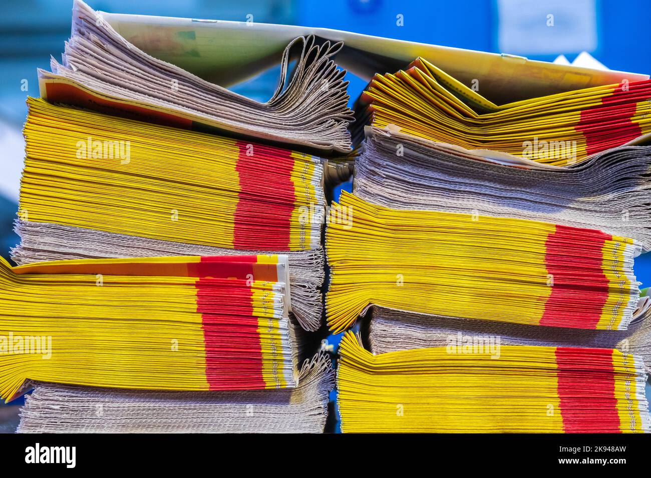 Bunch of paper newspaper with colorful pages stacked together in ...
