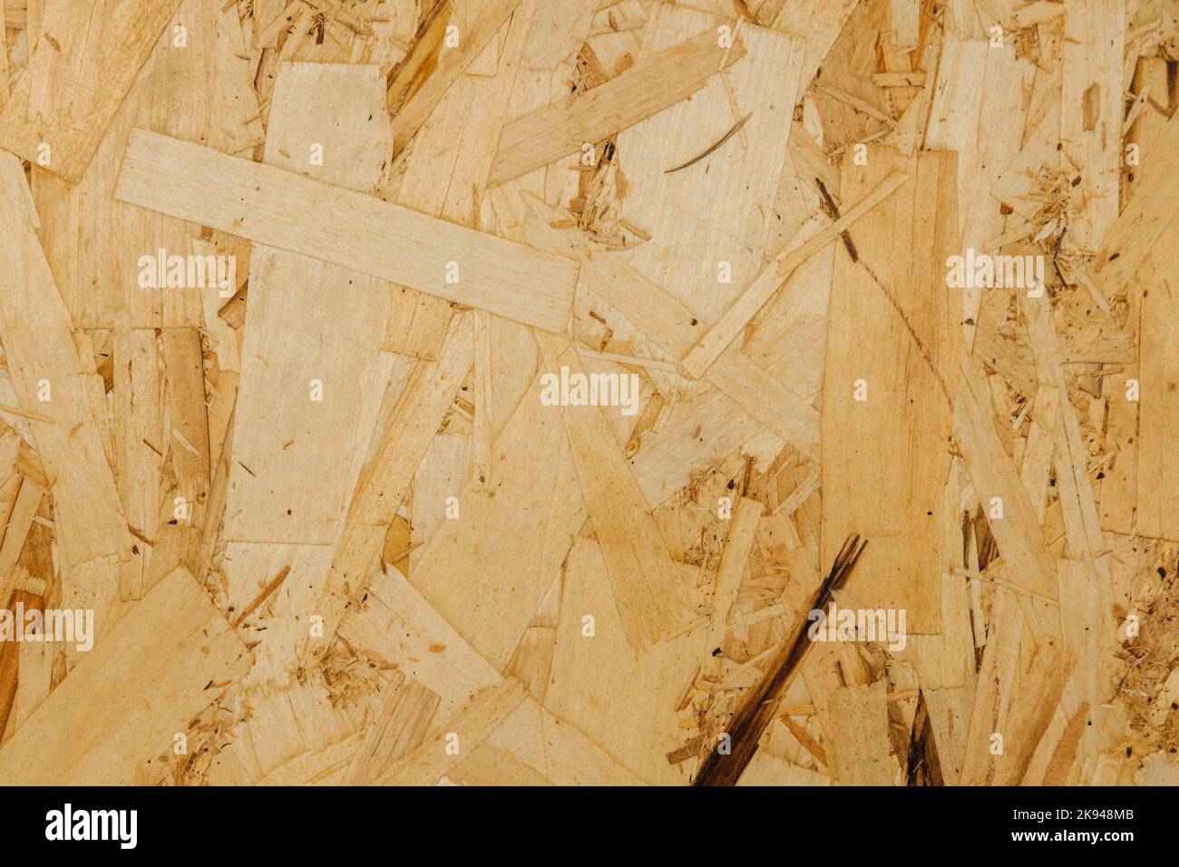 Close up pressed wooden panel background, texture of oriented strand ...