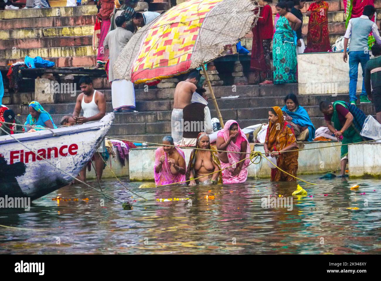 Varanasi, India - December 11, 2009: Hindu people wash themselves in ...