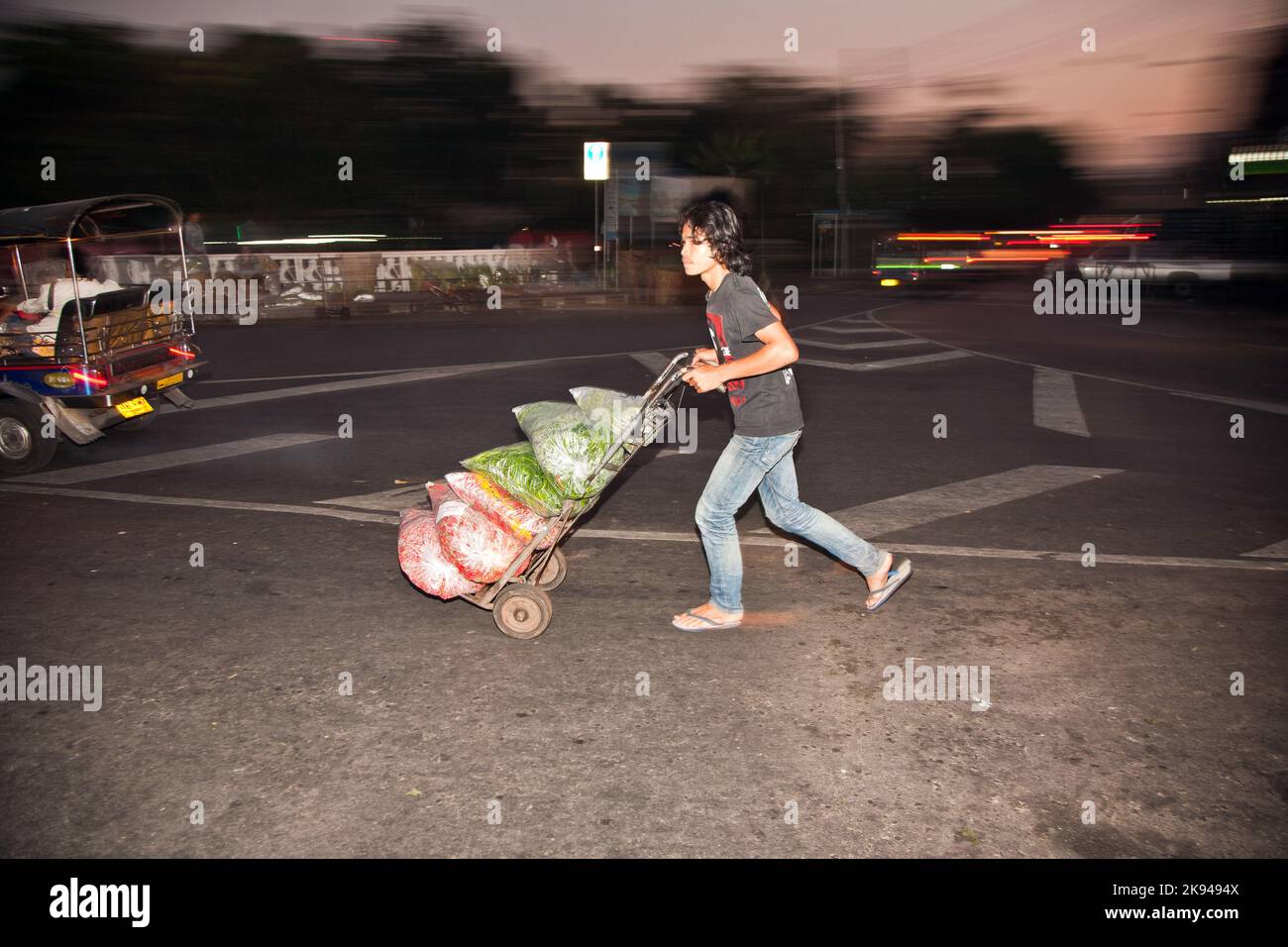 Bangkok, Thailand - December 23, 2009: people carrying their goods back ...