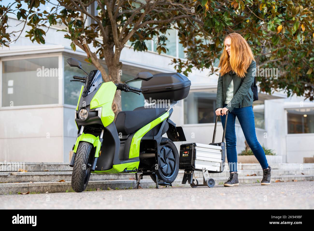 Girona, Spain, October 25, 2022. Woman removing the battery from a ...