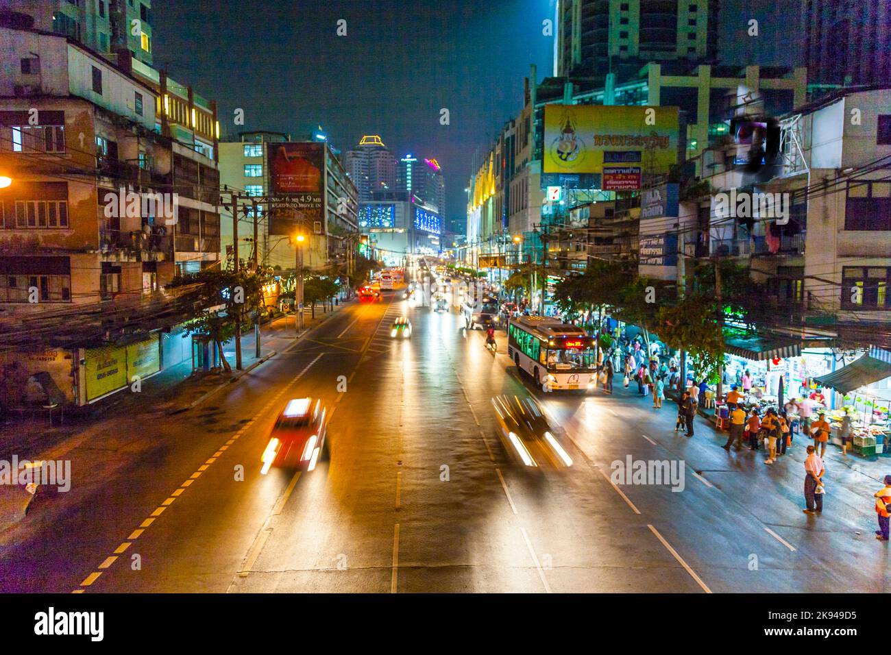 BANGKOK - JAN 1:cars by night on a main road in Bangkok with lights on ...