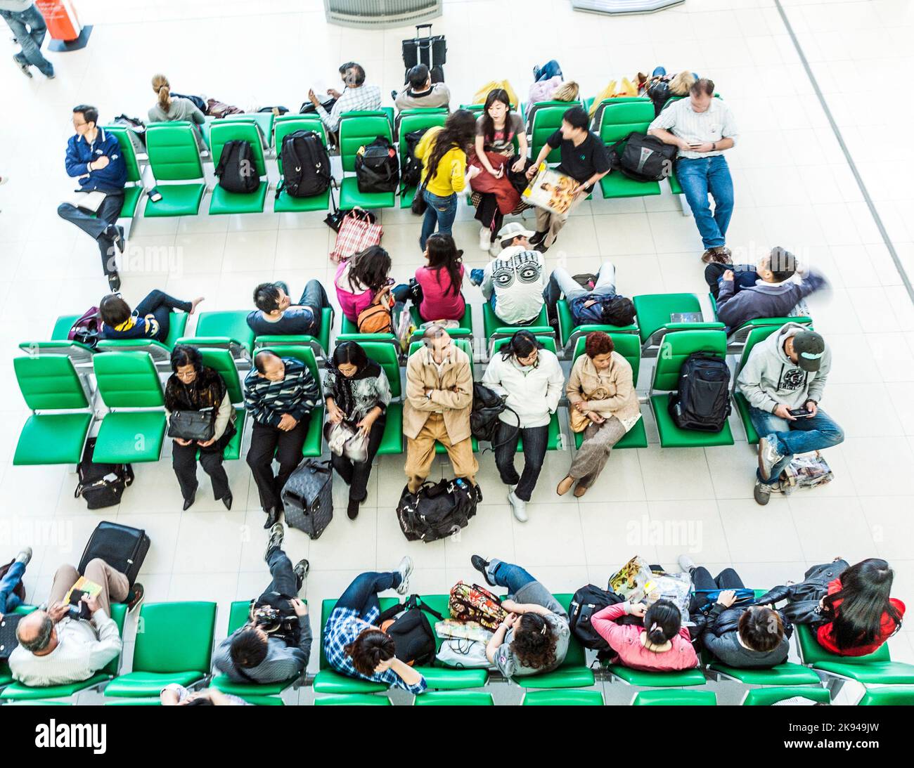 BANGKOK - JANUARY 5: passengers wait on benches for the departure of ...