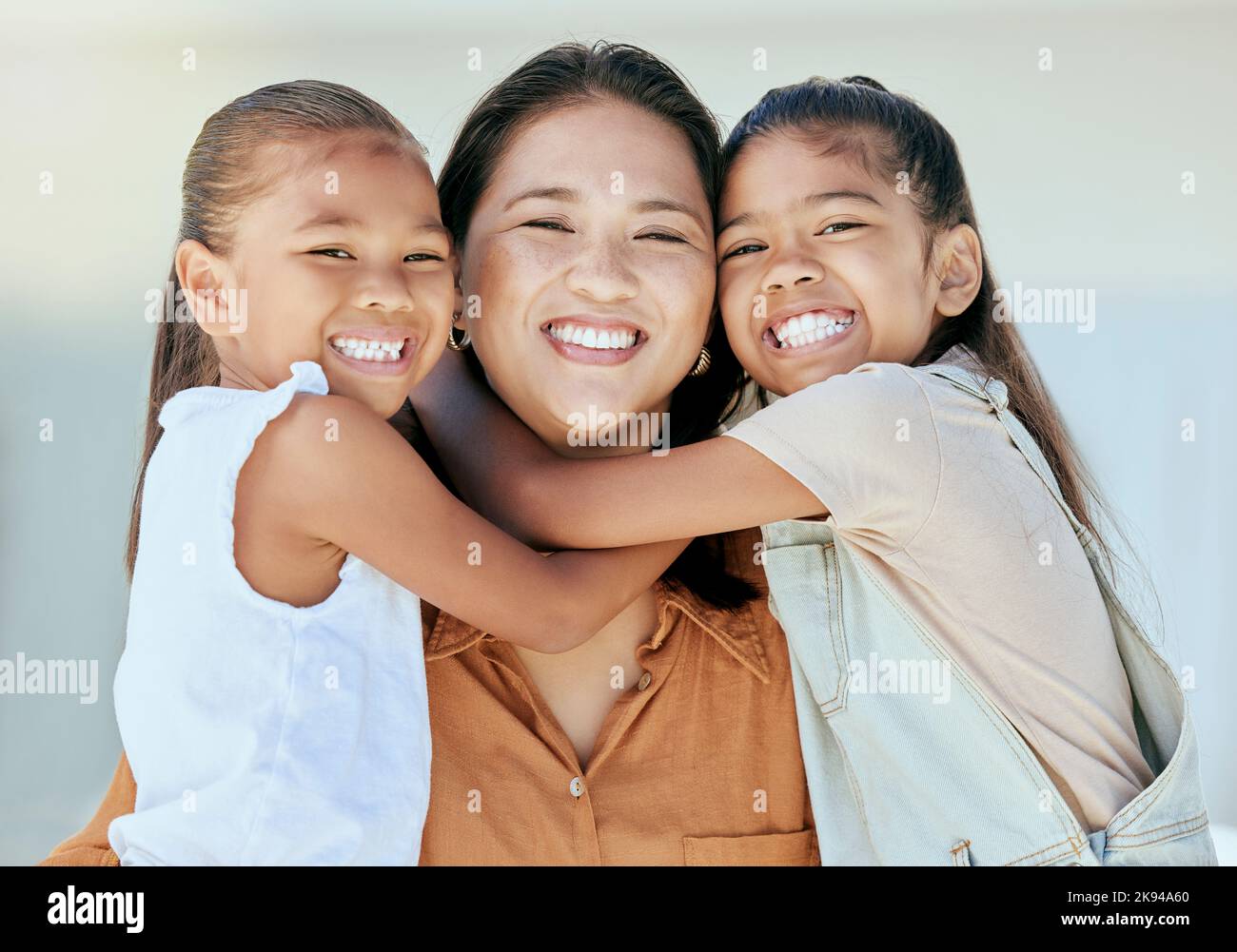Happy family, mother and girls hug in portrait, bonding and .enjoying ...
