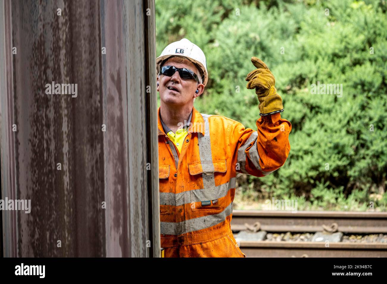Railway workers building new railway and knocking down bridges Stock ...