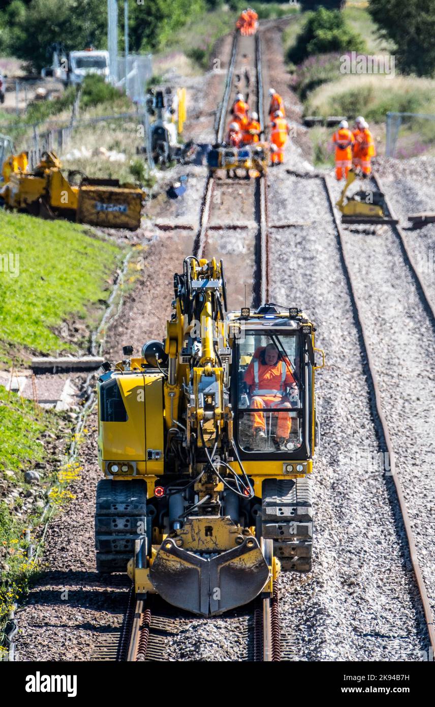 Railway workers building new railway and knocking down bridges Stock ...