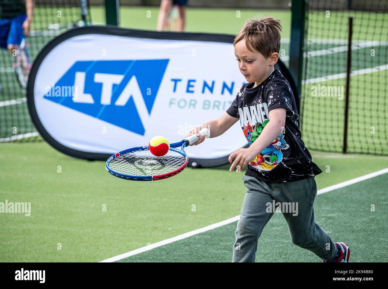 Children playing tennis and having tennis lessons Stock Photo - Alamy
