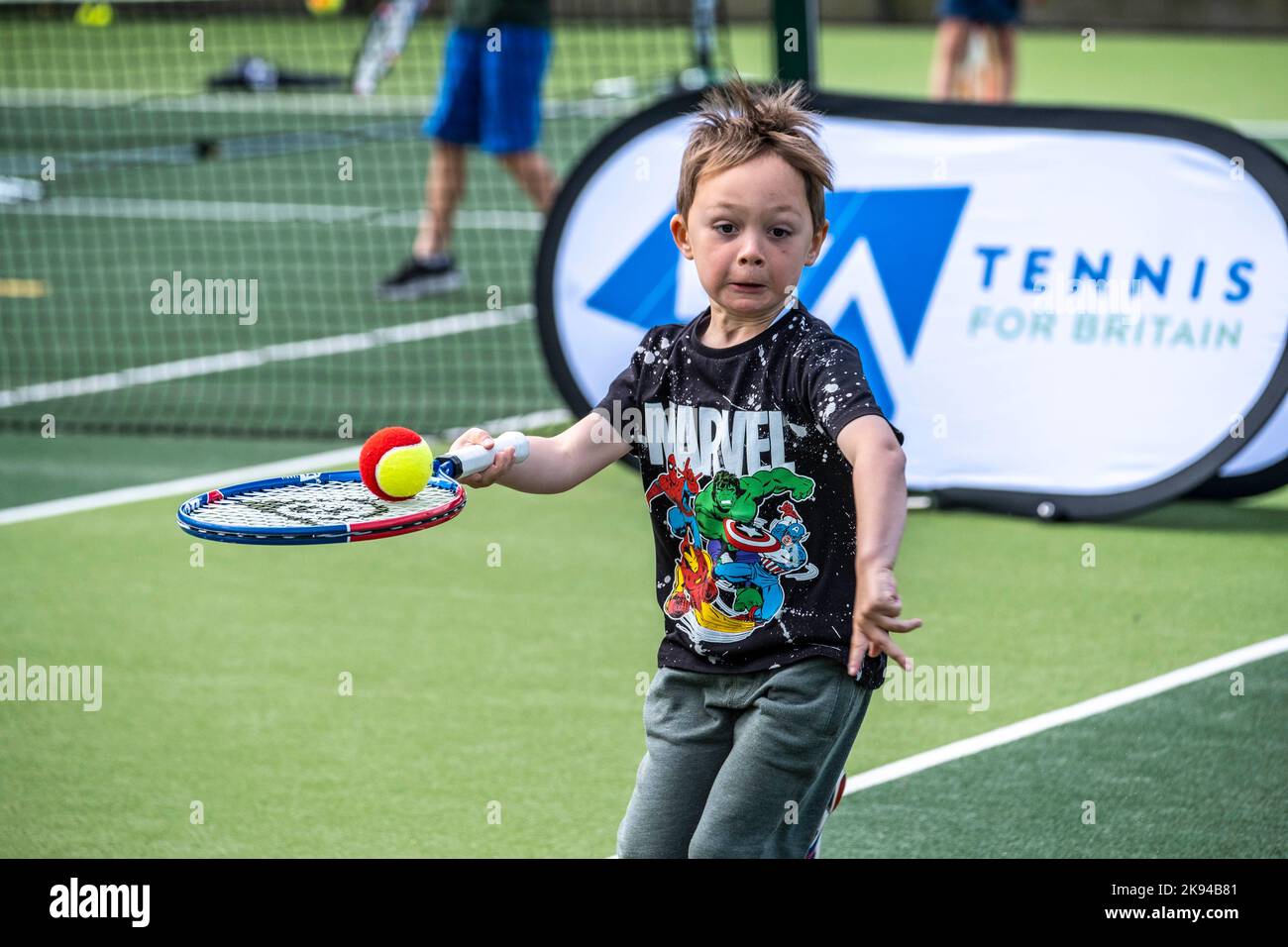 Children playing tennis and having tennis lessons Stock Photo - Alamy