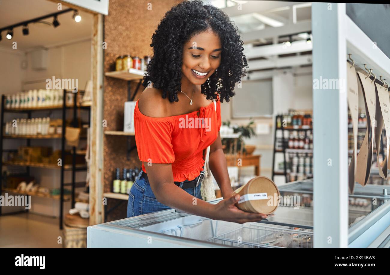 Shopping, supermarket and customer with product in groceries freezer ...