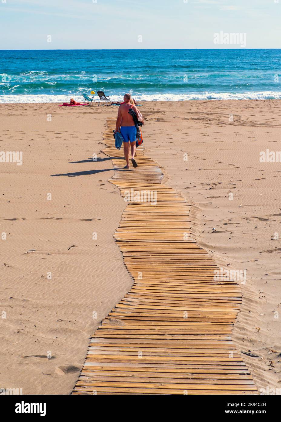 A tourist sunbathing on a lonely beach in Roses, Girona Stock Photo - Alamy