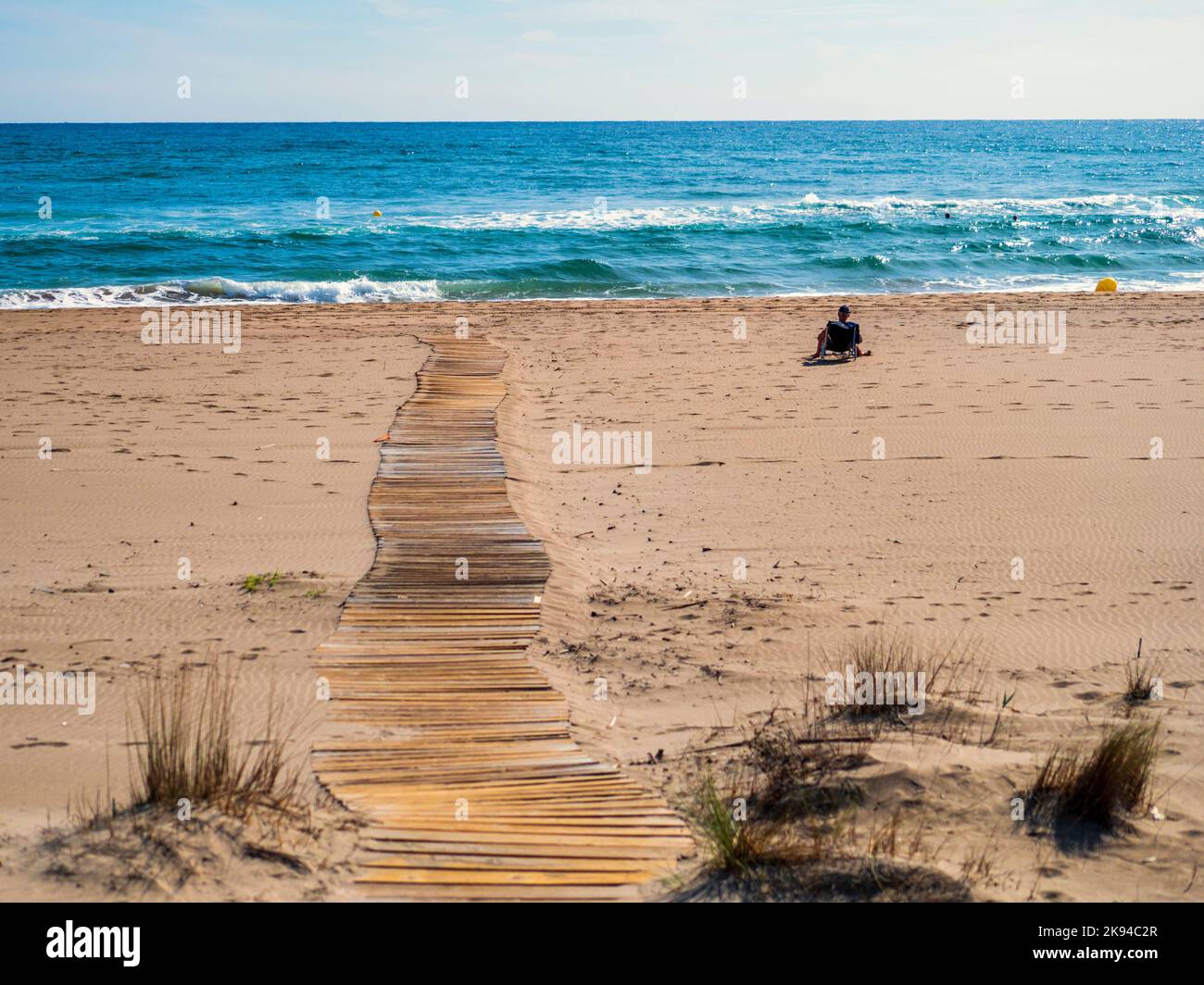 A tourist sunbathing on a lonely beach in Roses, Girona Stock Photo - Alamy
