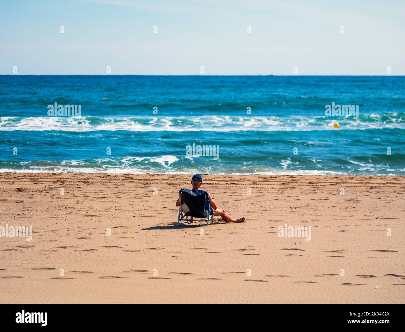 A tourist sunbathing on a lonely beach in Roses, Girona Stock Photo - Alamy