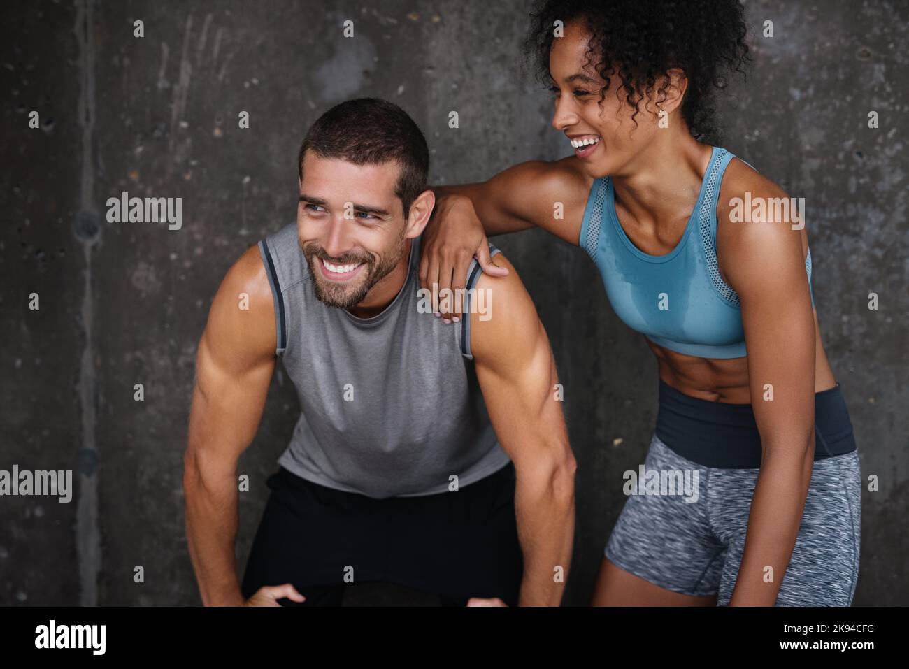 Working out together is always fun. a sporty young couple resting ...