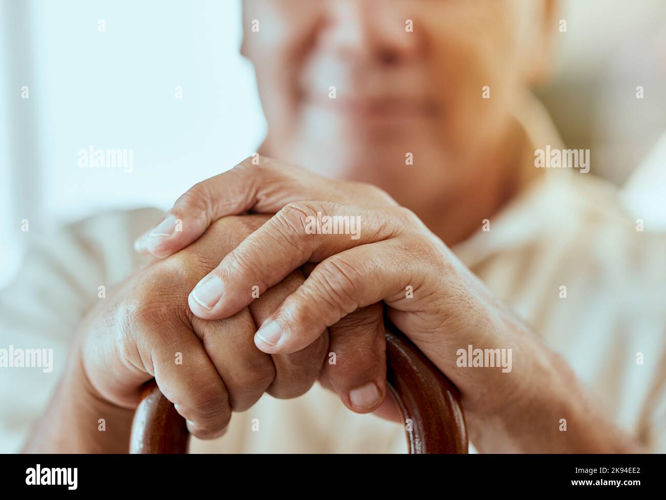 Senior man, hands and cane for disability, arthritis or osteoporosis in home. Closeup ...