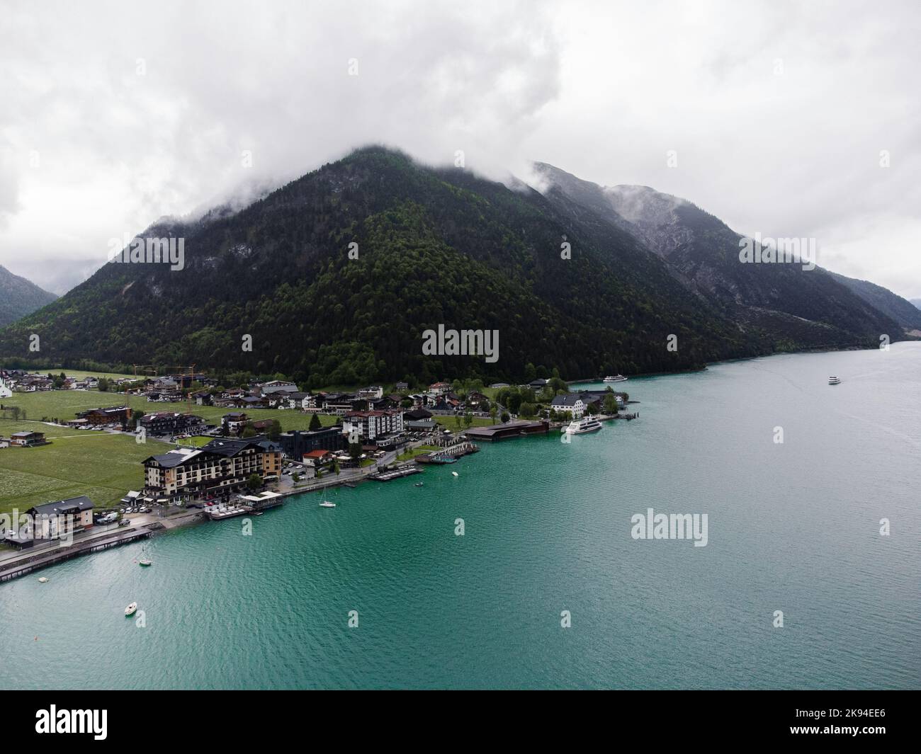 An aerial of the Achen lake's coastline with boats in Achensee region ...
