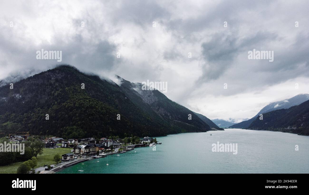 An aerial of the Achen lake's coastline with boats in Achensee region ...