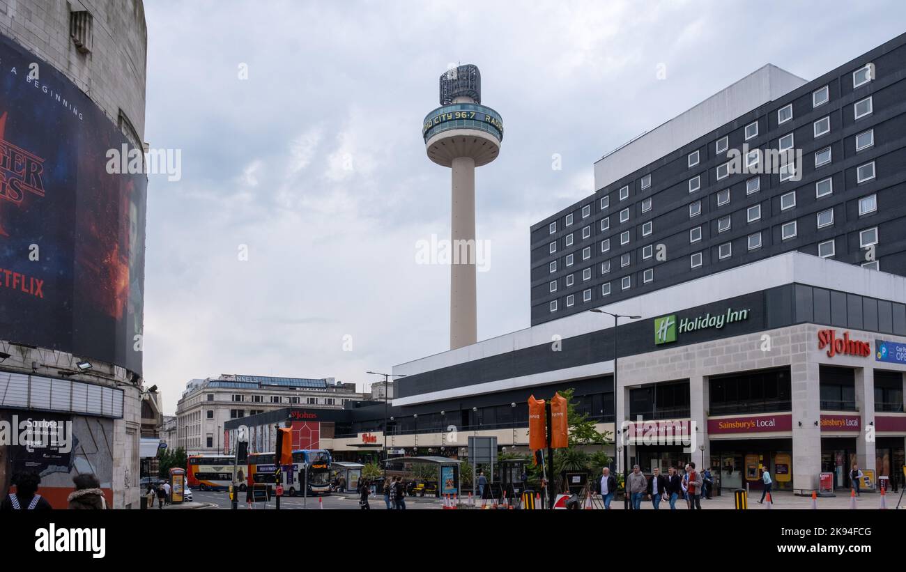 The Radio City Tower by end of a modern street with buildings and ...