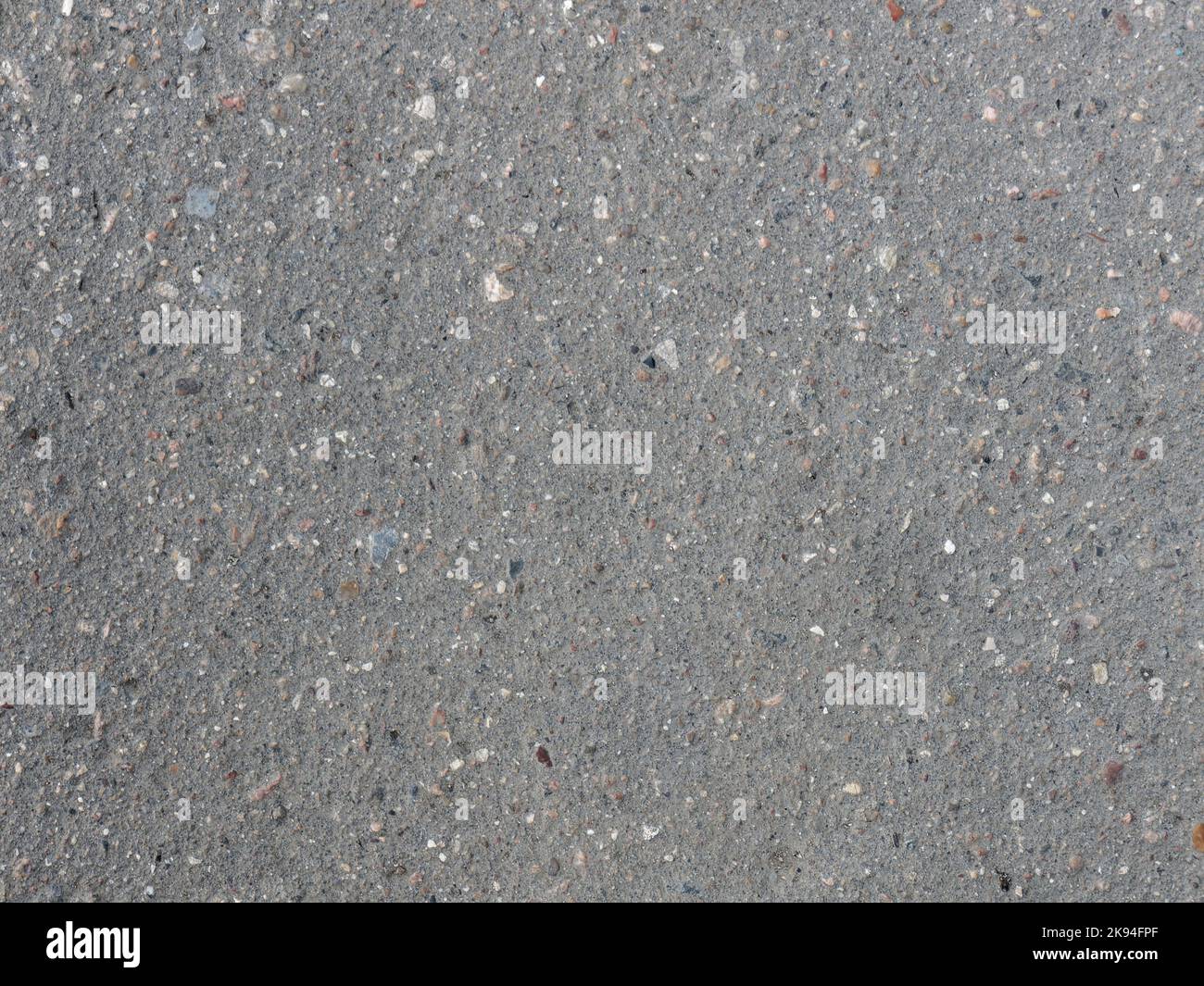 Background from old asphalt with potholes and splashes of light stones ...