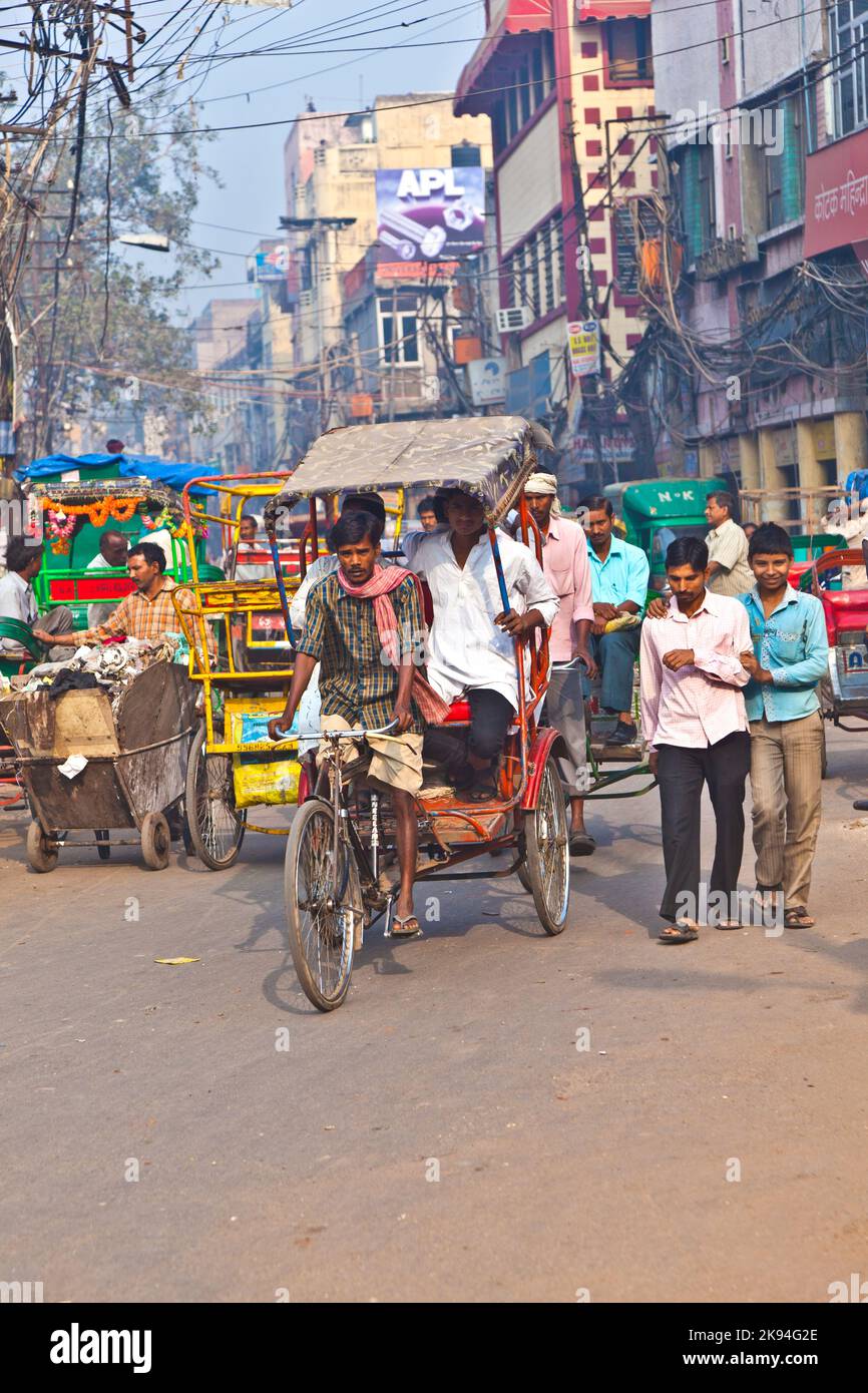 Delhi, India - November 9, 2011: Rickshaw rider transports passenger ...
