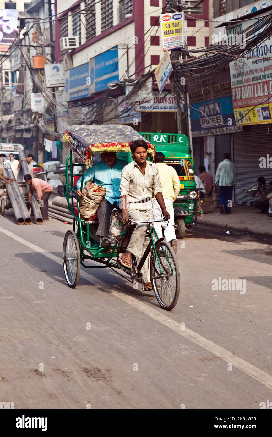 Delhi, India - November 9, 2011: Rickshaw rider transports passenger ...