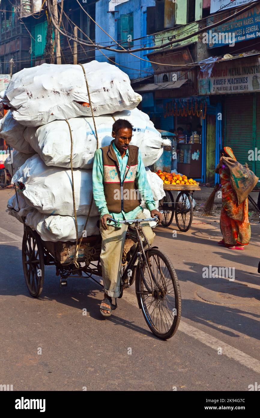 Delhi, India - November 9, 2011: Rickshaw rider transports cargo early ...