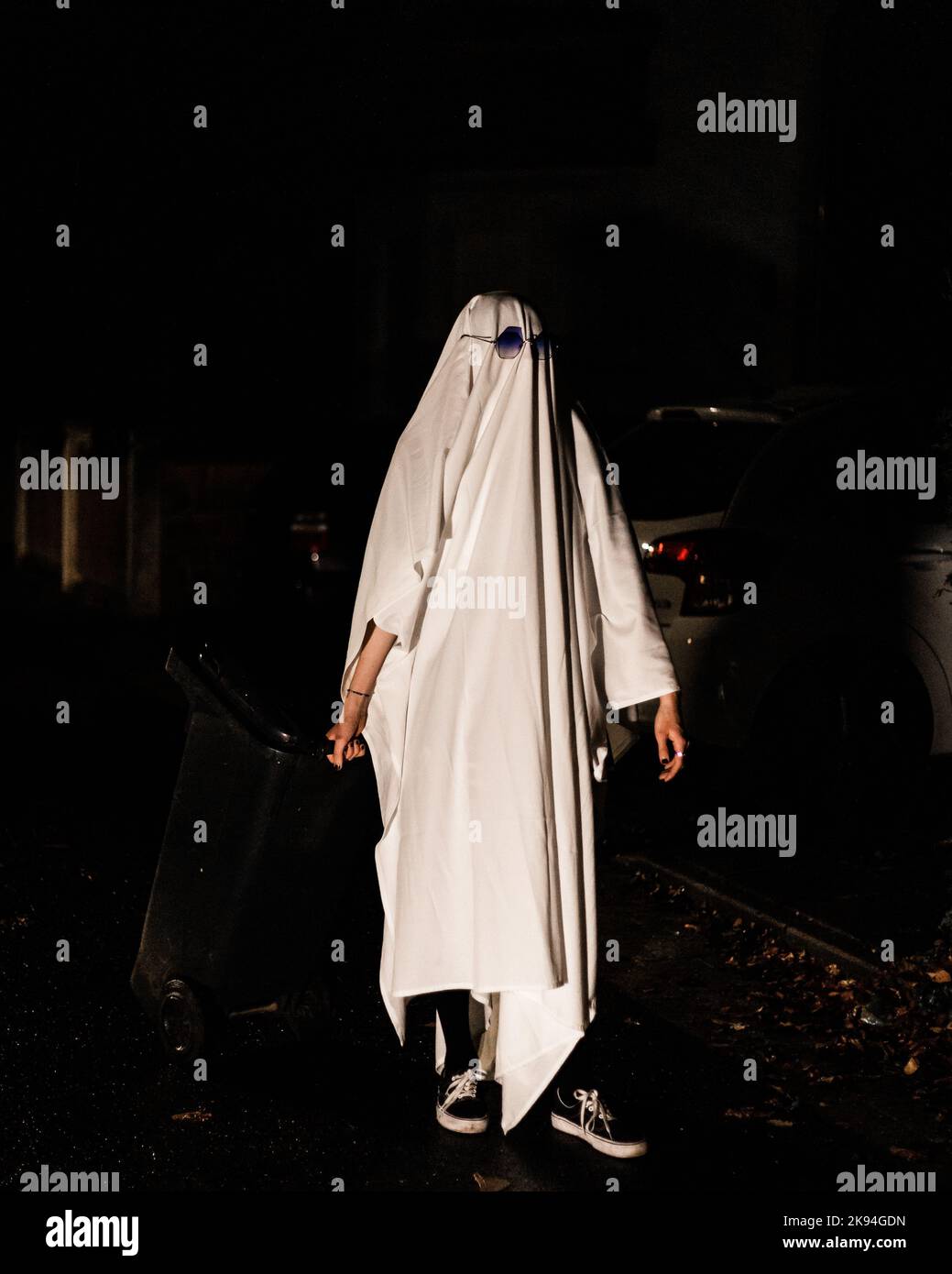 A human wearing ghost costume and walking in dark street at night Stock ...