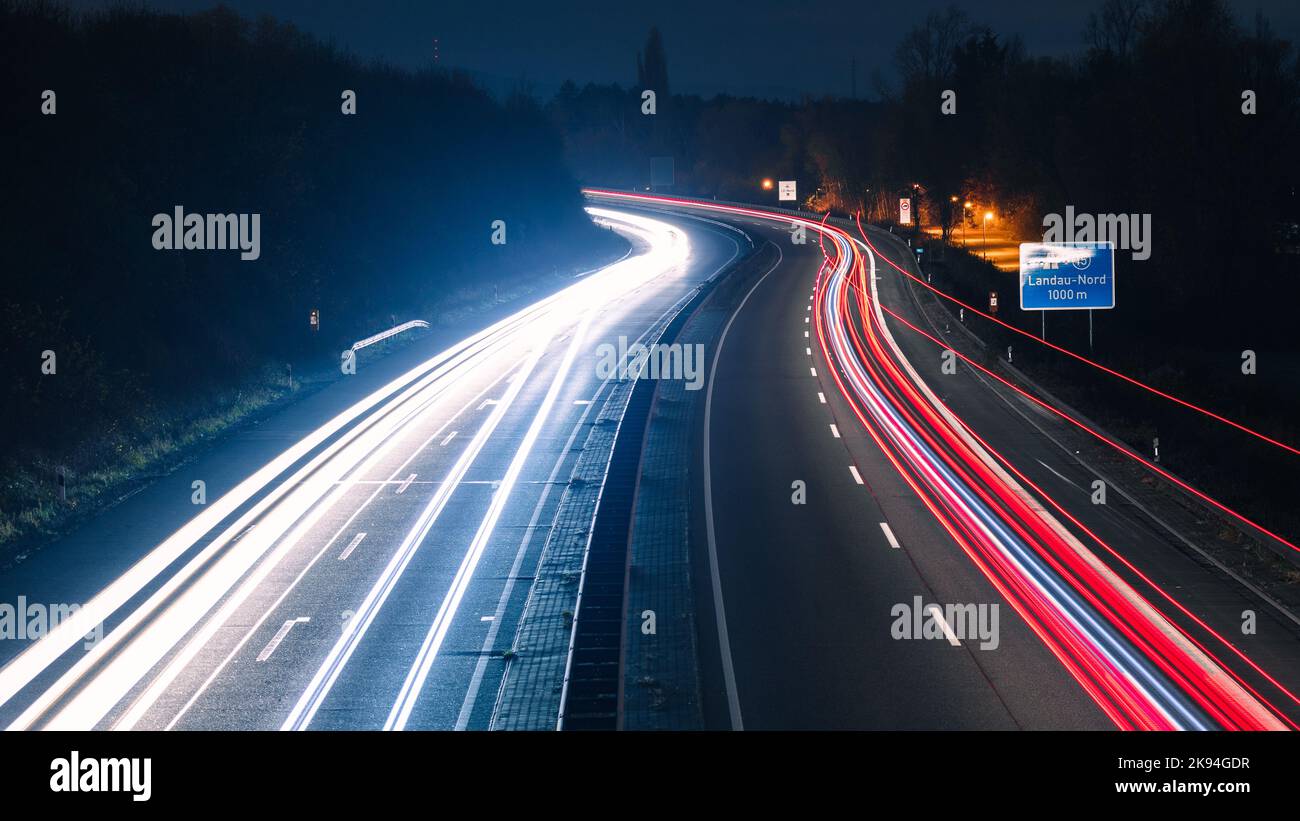 A long exposure shot of the cars lights on a highway road at night ...