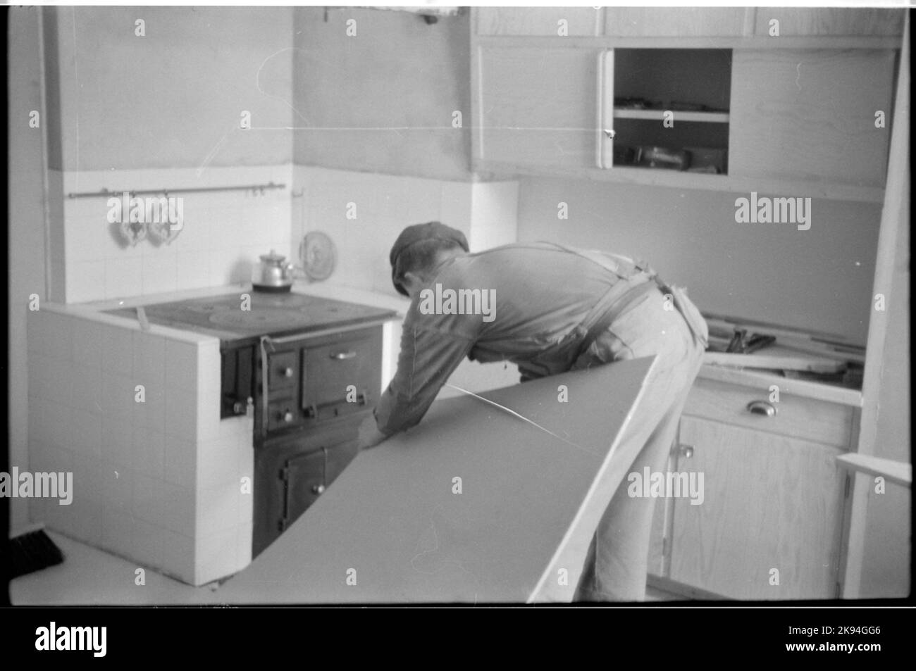 Construction workers in the kitchen Stock Photo - Alamy