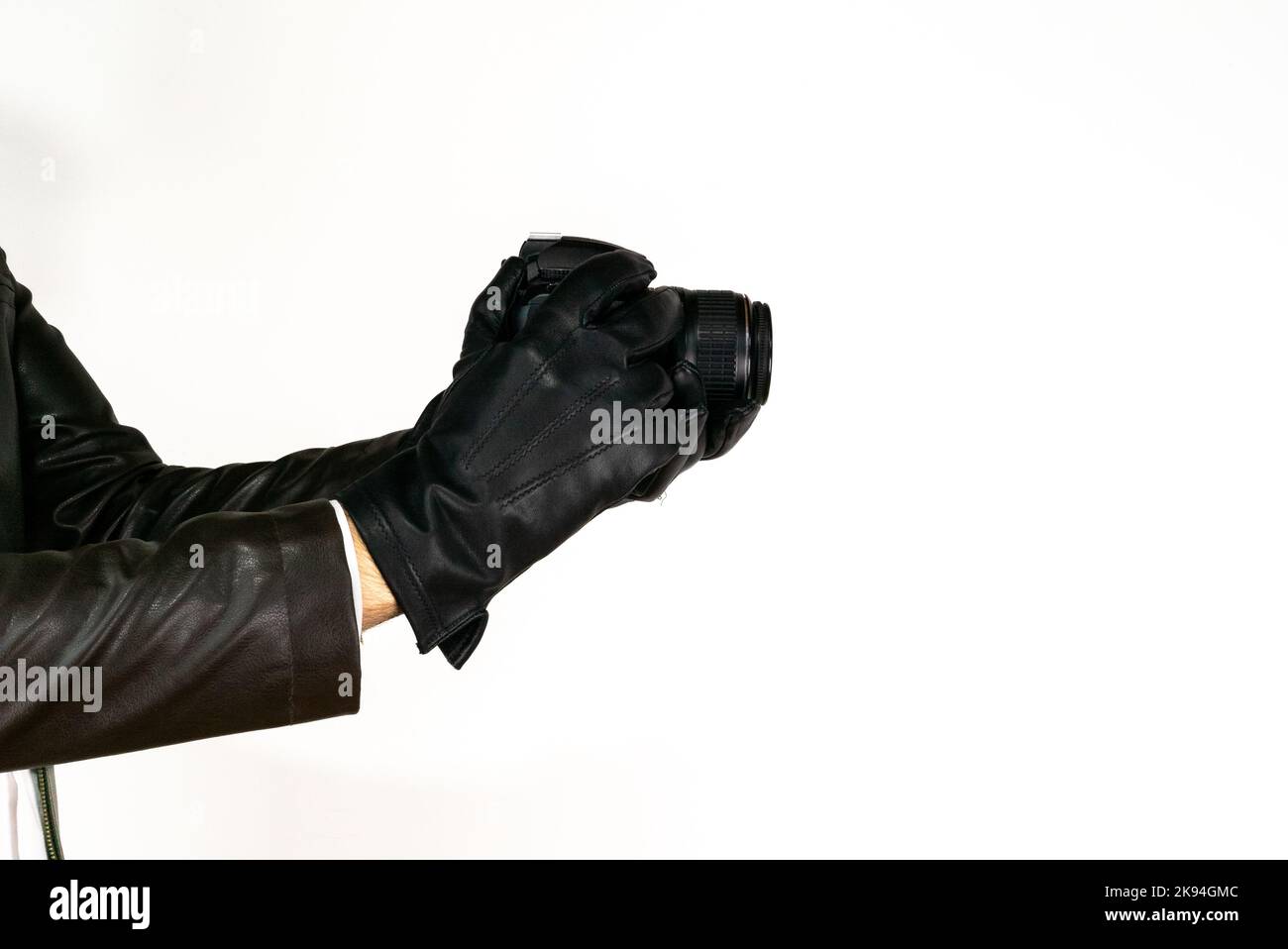 Men photographer taking a photo with black leather glove. A male spy ...