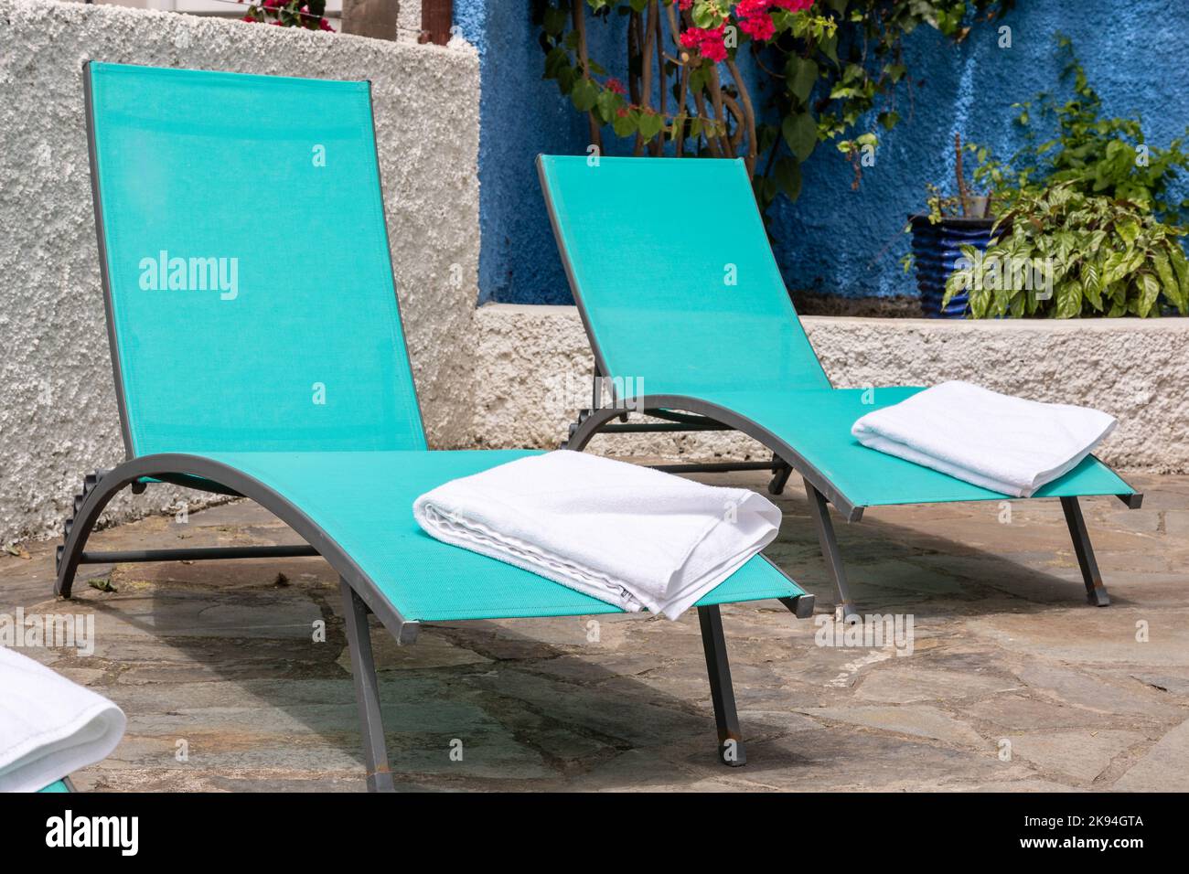 Two sunbeds with towels on them outdoors Stock Photo - Alamy