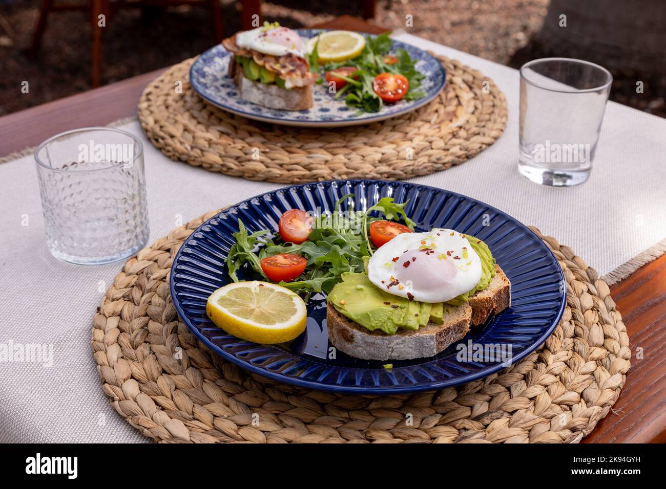 A high angle view of poached eggs with vegetables on plates in cafe ...
