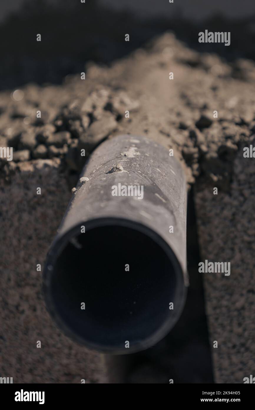 A vertical shot of a sewer pipe being built under ground Stock Photo ...