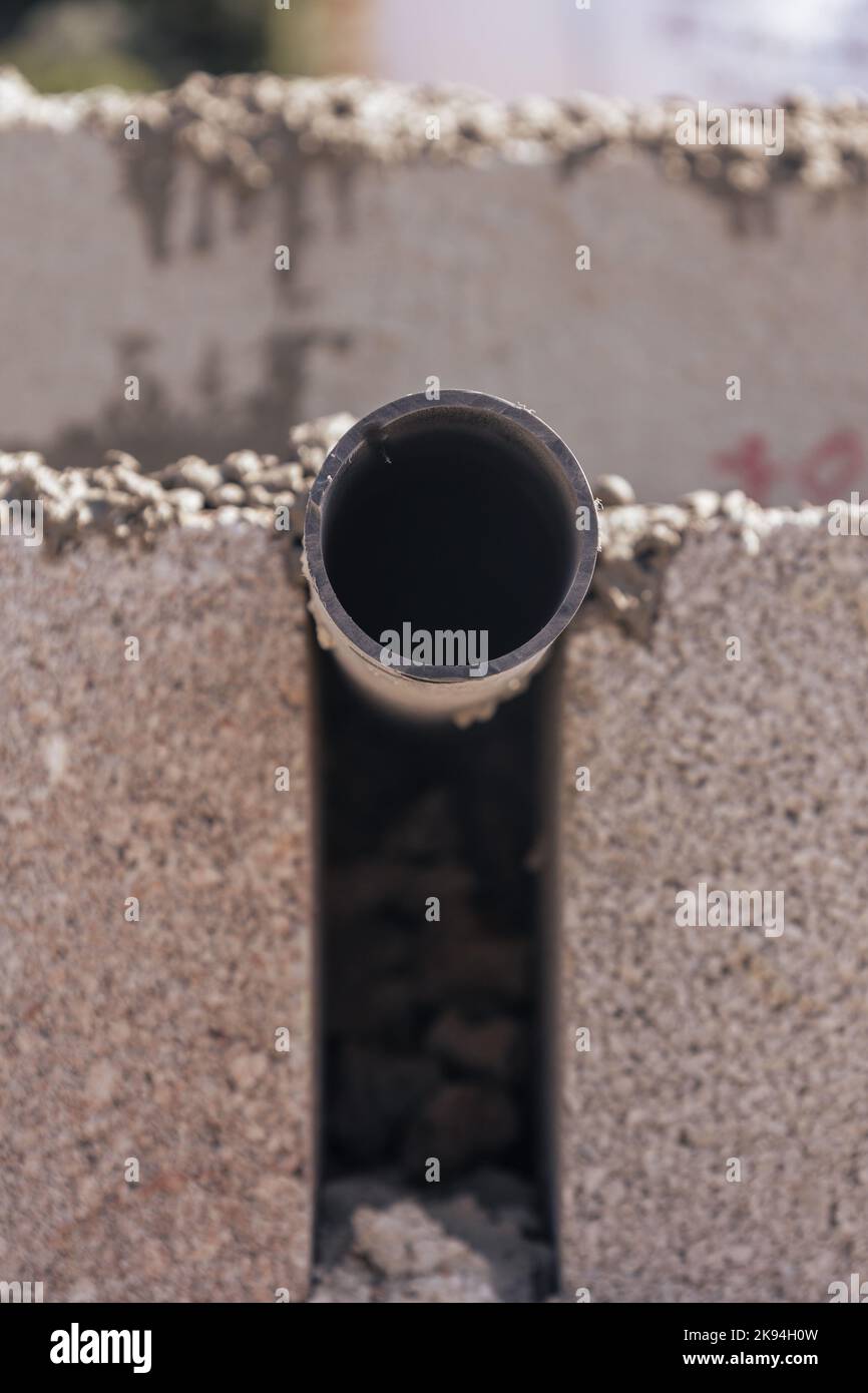 A vertical shot of a sewer pipe being built under ground Stock Photo ...