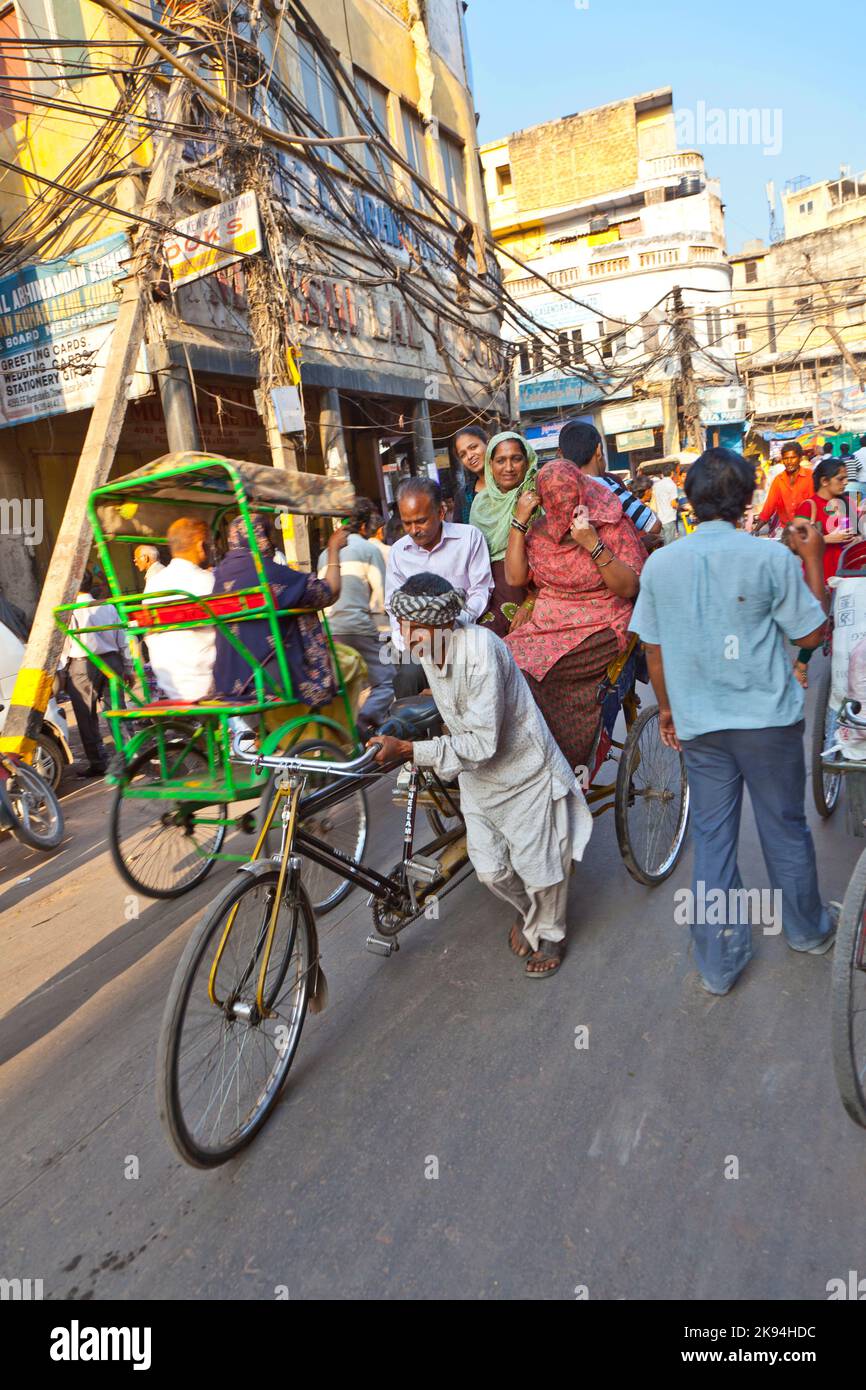 DELHI, INDIA - NOV 8: Rickshaw rider transports passenger early morning ...