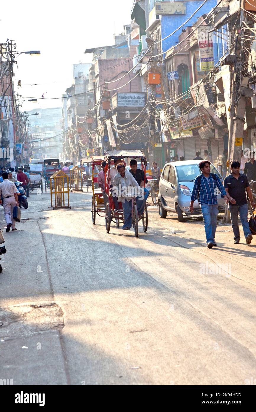 DELHI, INDIA - NOV 8: Rickshaw rider transports passenger early morning ...