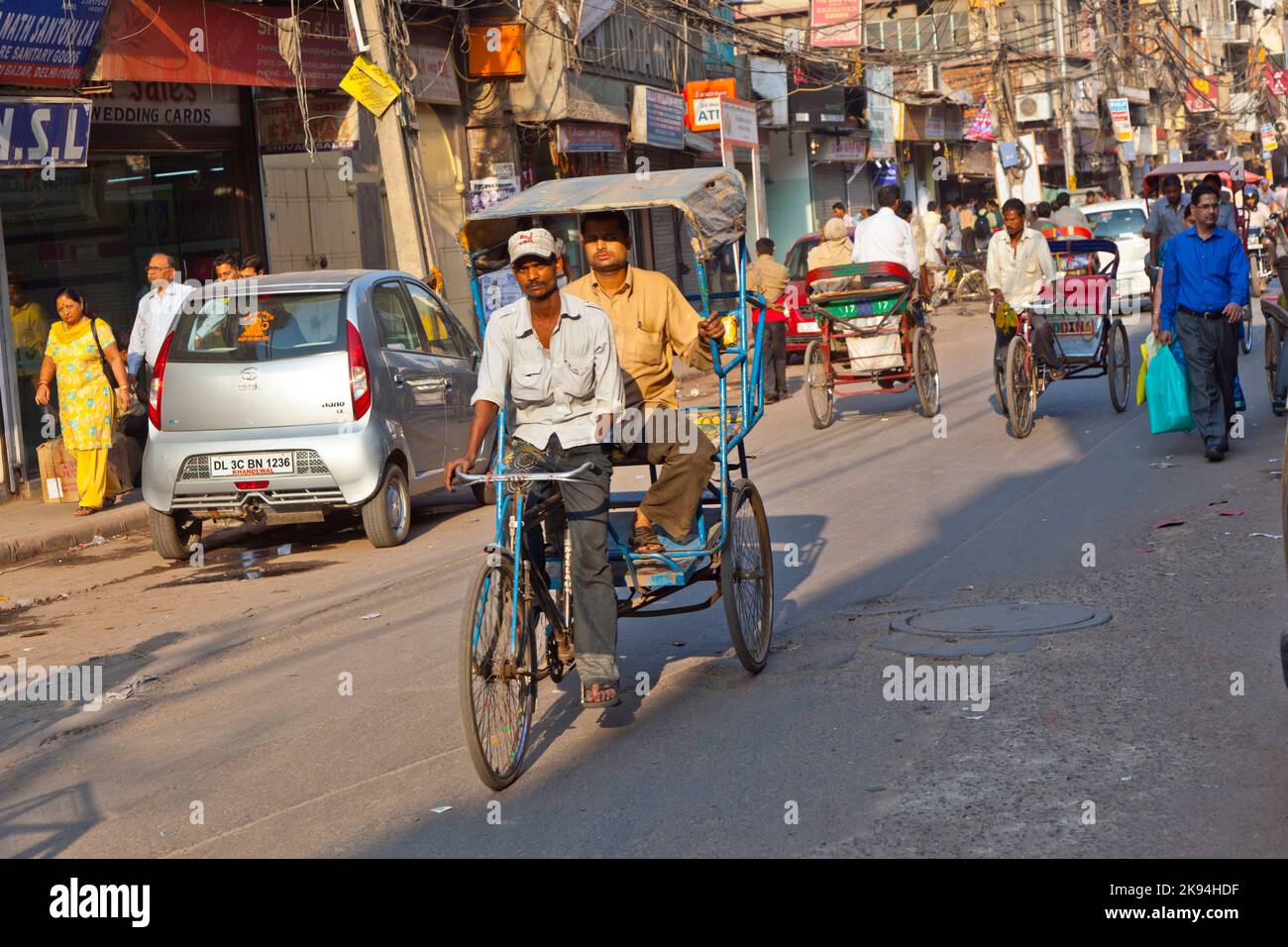 DELHI, INDIA - NOV 8: Rickshaw rider transports passenger early morning ...