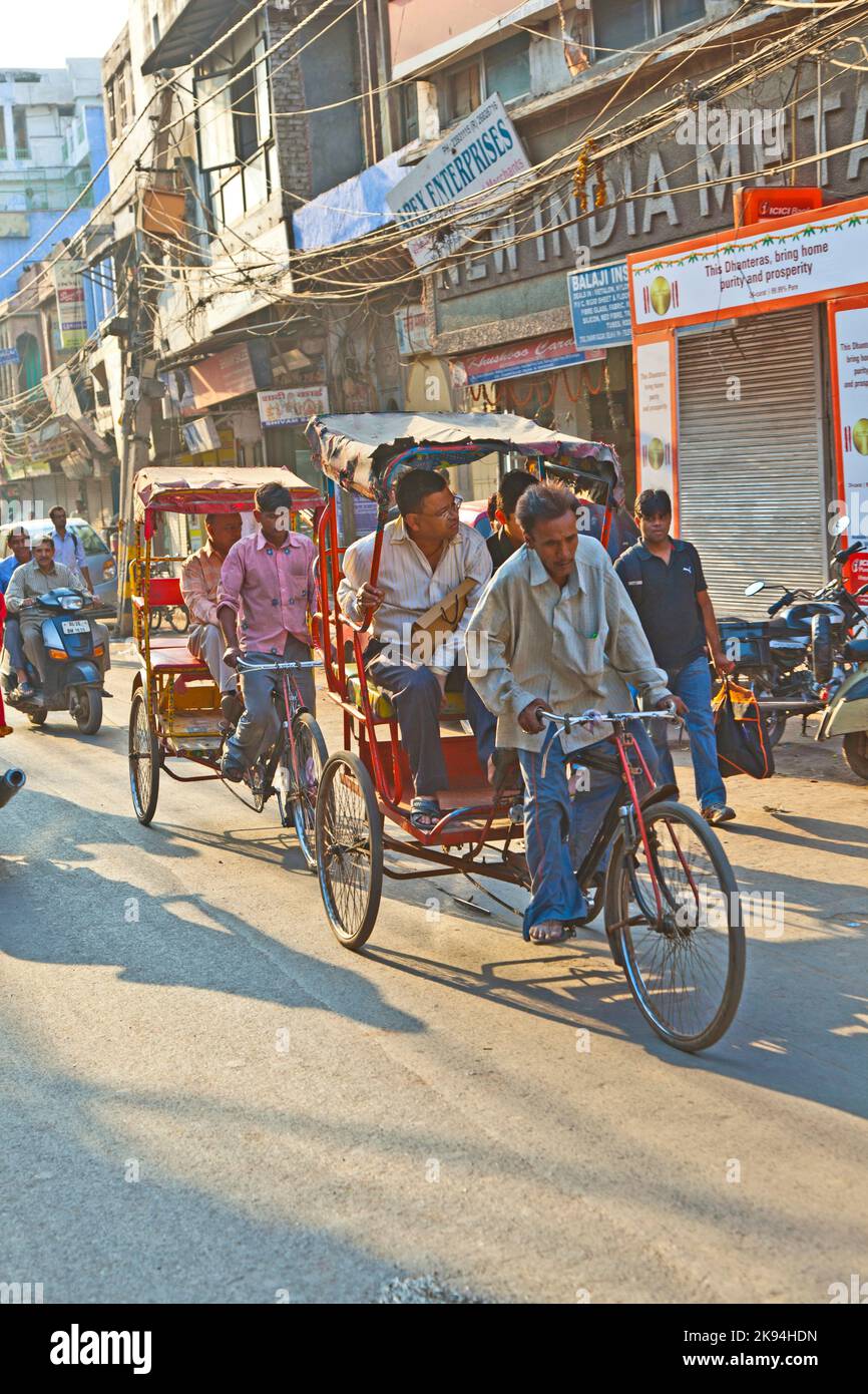 DELHI, INDIA - NOV 8: Rickshaw rider transports passenger early morning ...