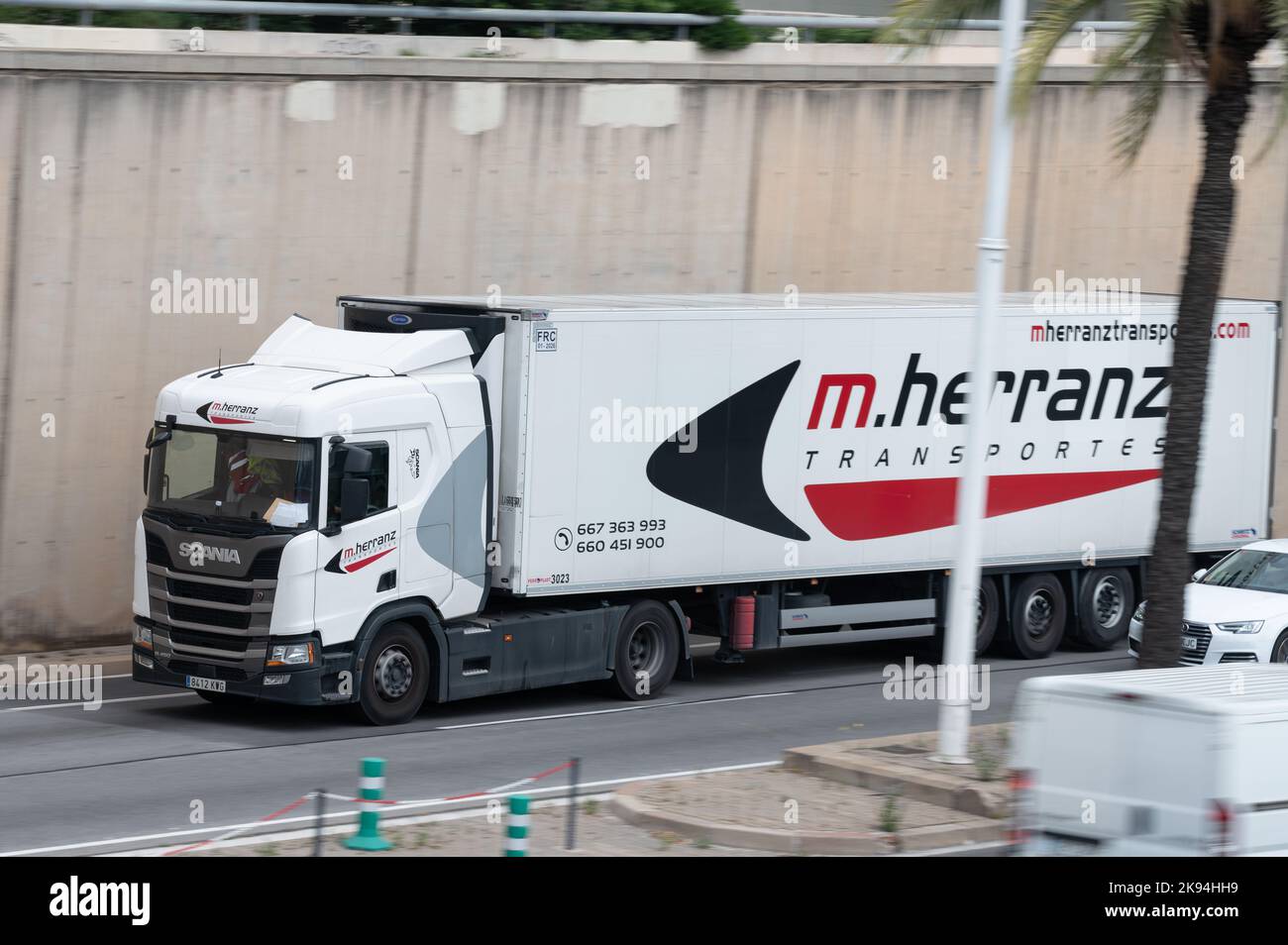 A Scania R450 truck loading a white container trailer along the Ronda ...
