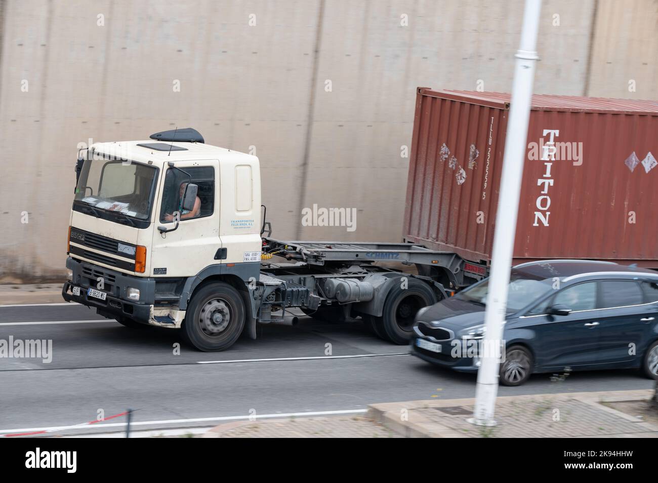 An old White DAF CF 85 truck loading a red container trailer along ...