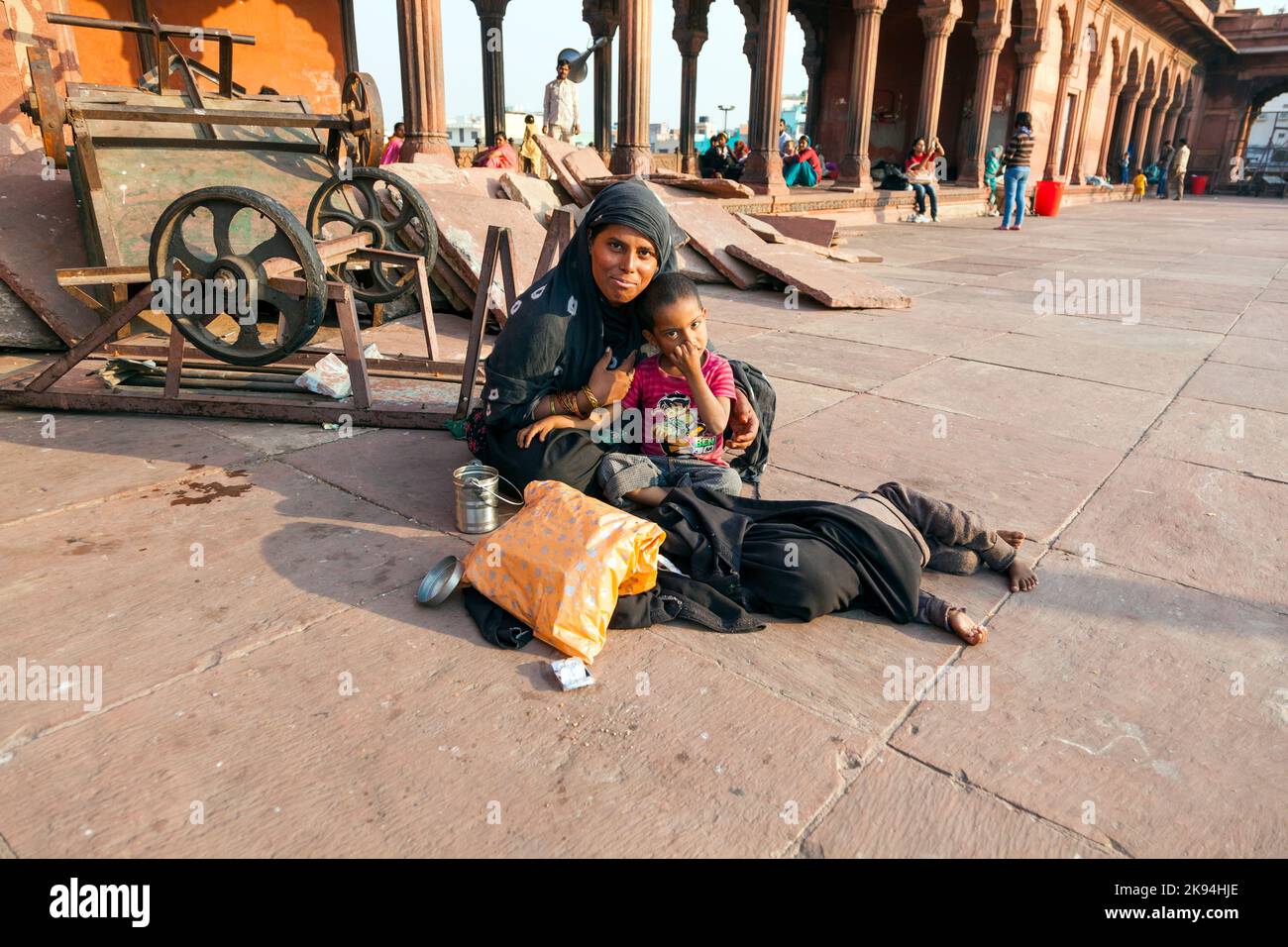 DELHI, INDIA - NOV 8: mother with child rests on the courtyard of Jama ...