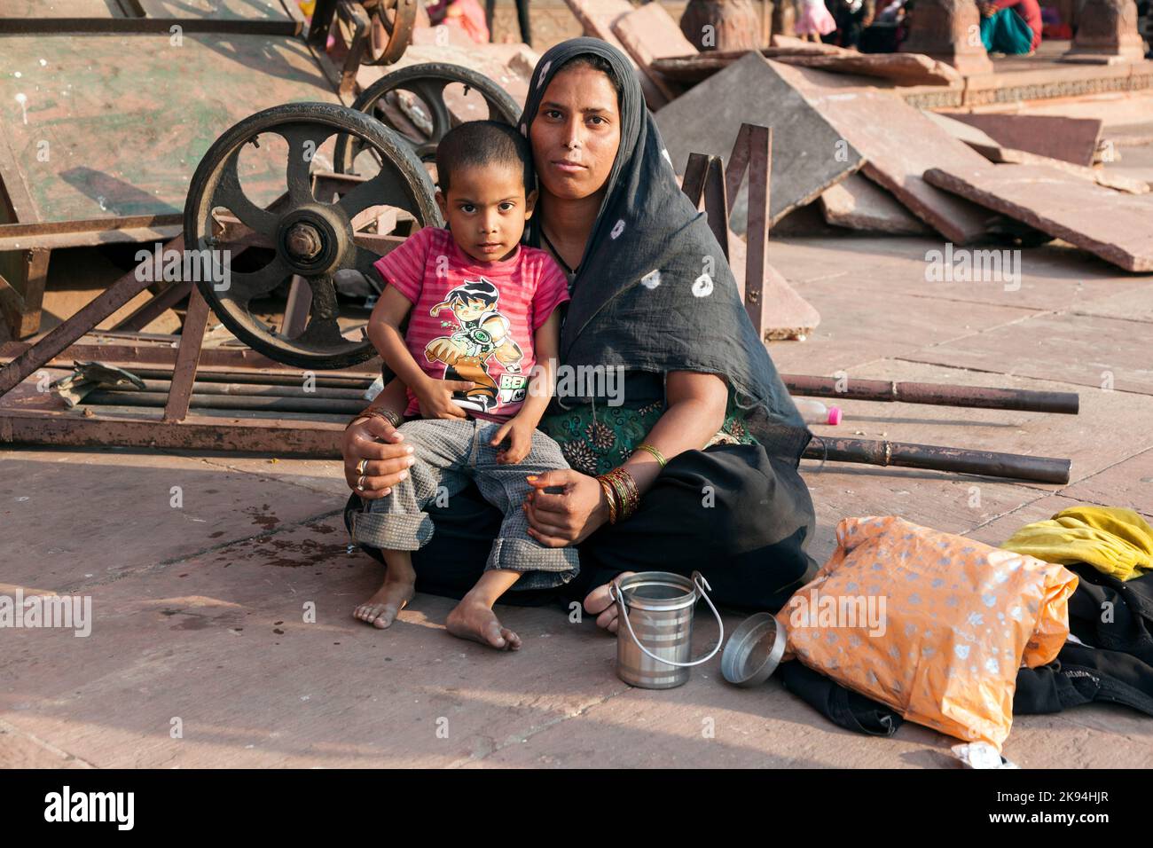 DELHI, INDIA - NOV 8: mother with child rests on the courtyard of Jama ...