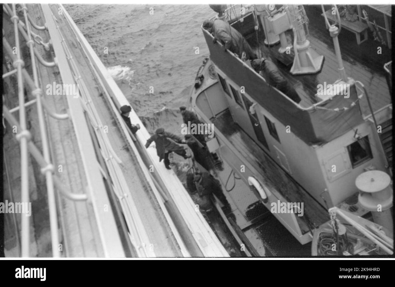 Man from vessels boards a pilot boat Stock Photo - Alamy