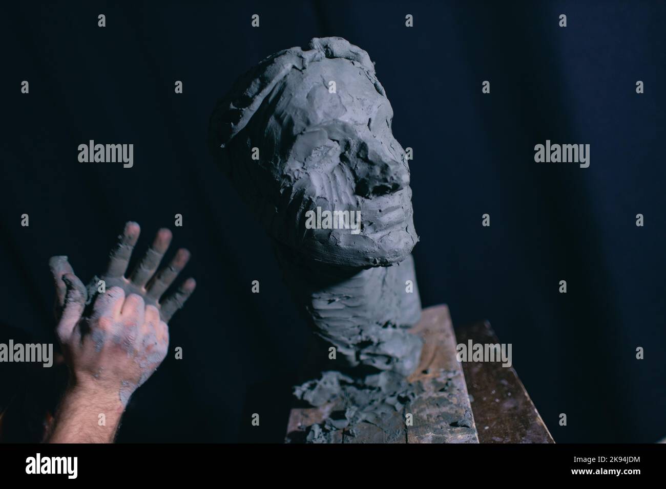 Man sculptor creates sculpt bust clay human woman sculpture. Statue ...