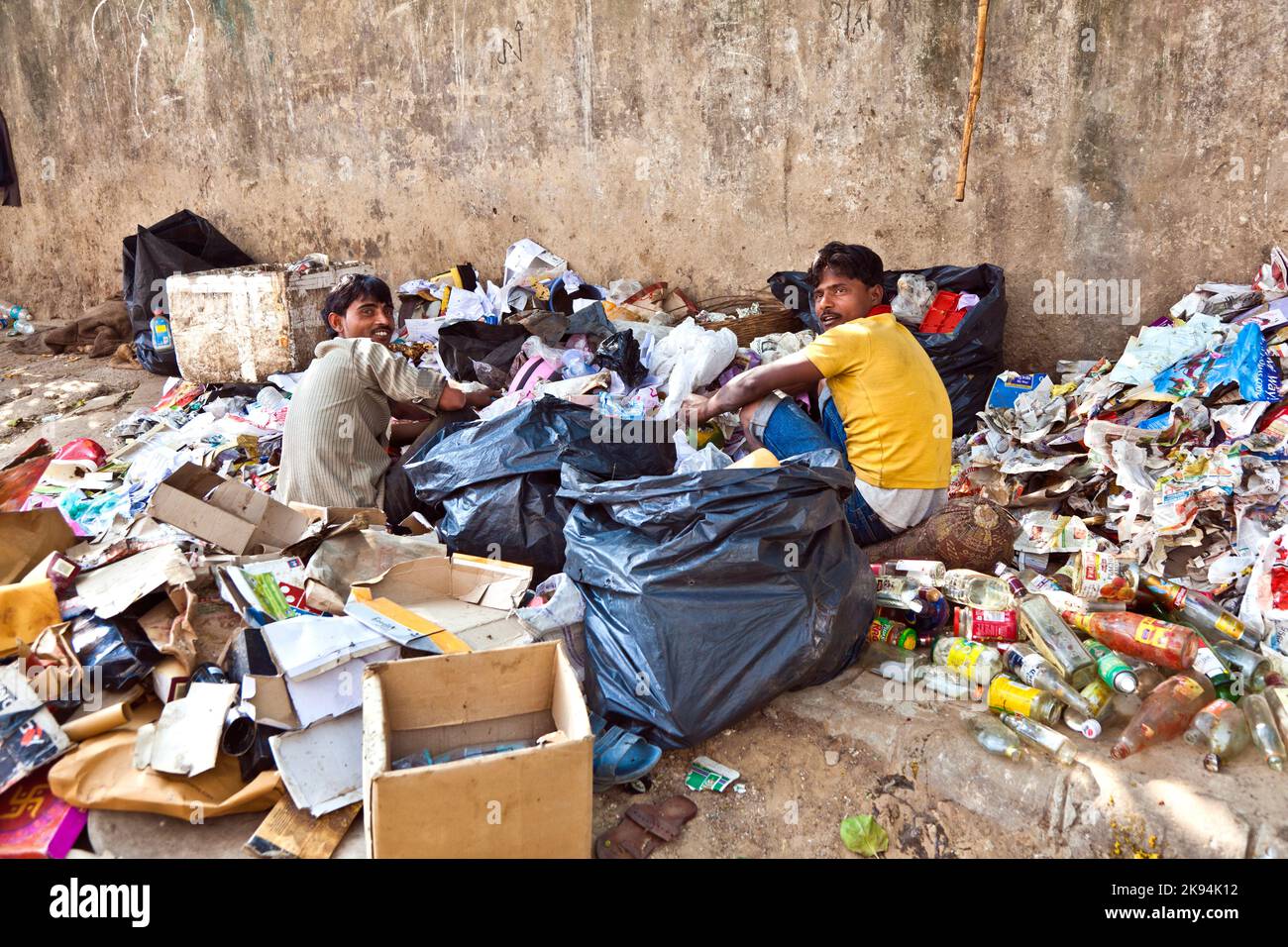 DELHI, INDIA - NOVEMBER 18: poor worker checking garbage for plastic ...